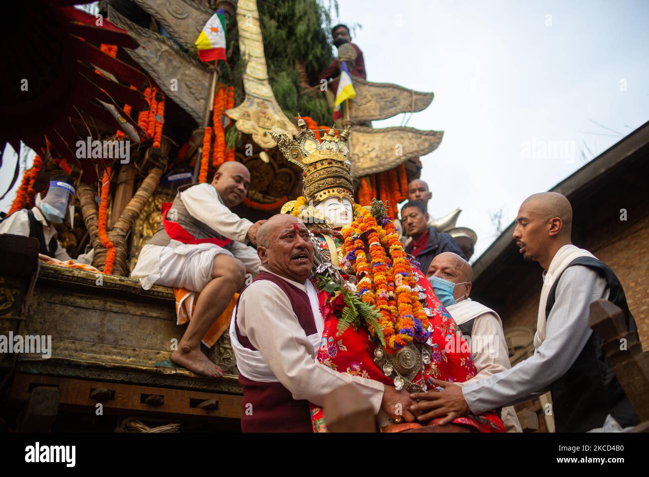 Hindu Priest carries the idol of Seto Machindranath towards chariot ...