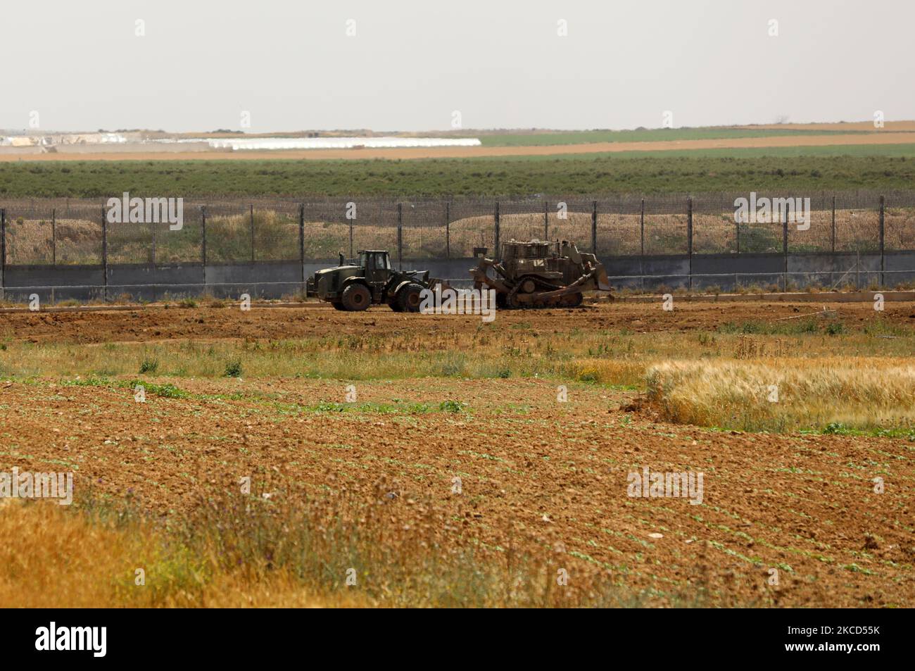 Israeli bulldozers work at the Israel-Gaza border, east of Gaza City on ...