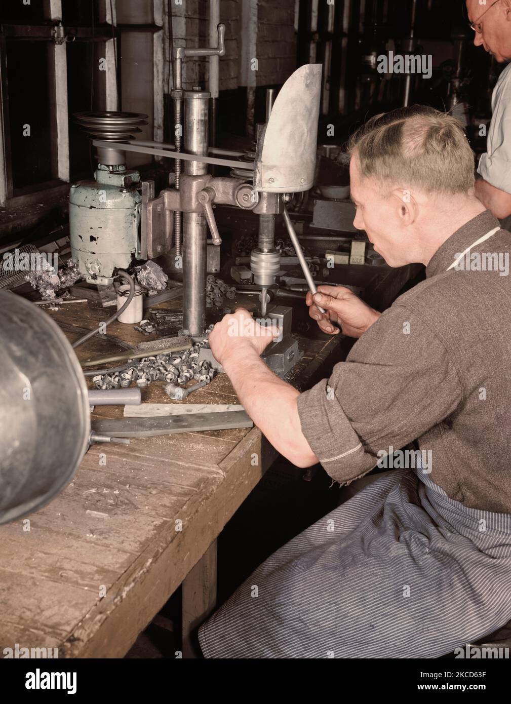 Man operating drill press making vital parts war production hi-res ...