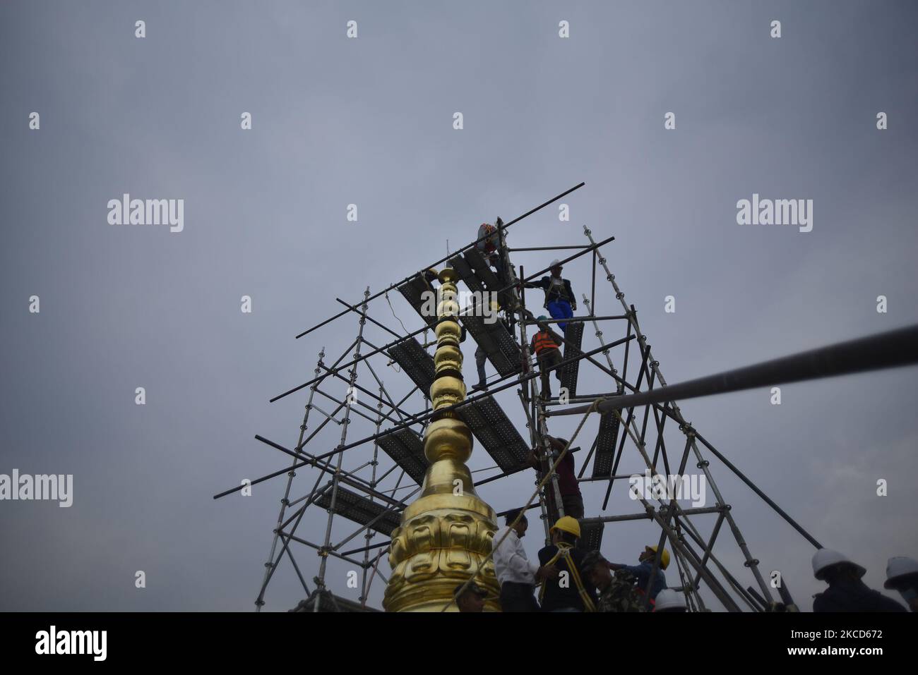 Installing final gold plated pinnacle hi-res stock photography and ...