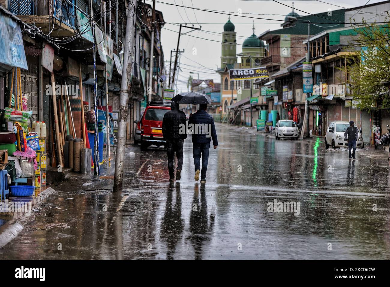 Kashmir men with umbrella on a rainy day amid COVID-19 Coronavirus ...