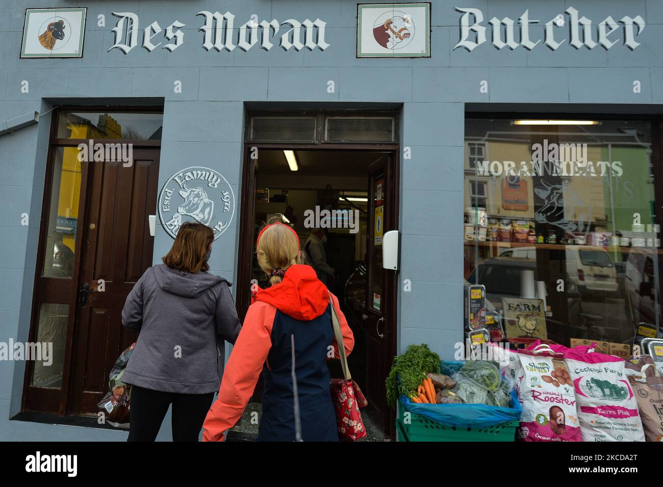 Two customers wait outside of Moran Family Butchers in Clifden center ...