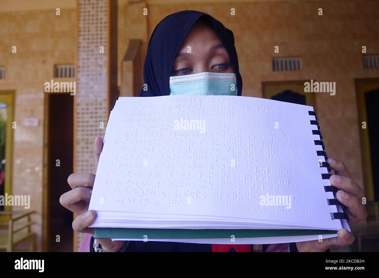 Meysari, a 20-year-old blind woman with blue eyes reading the Koran in ...