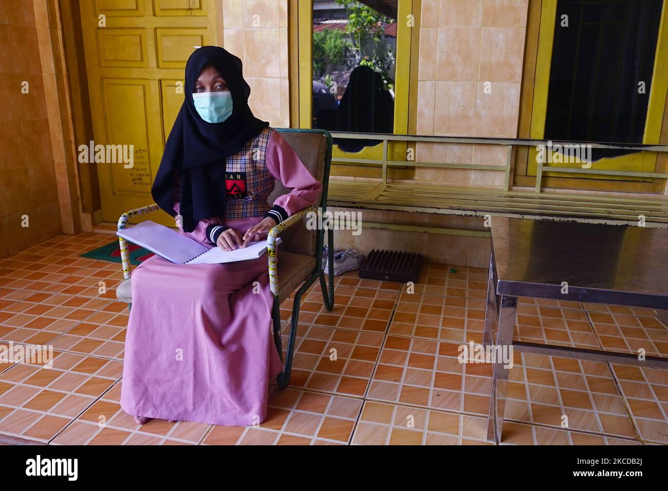 Meysari, a 20-year-old blind woman with blue eyes reading the Koran in ...