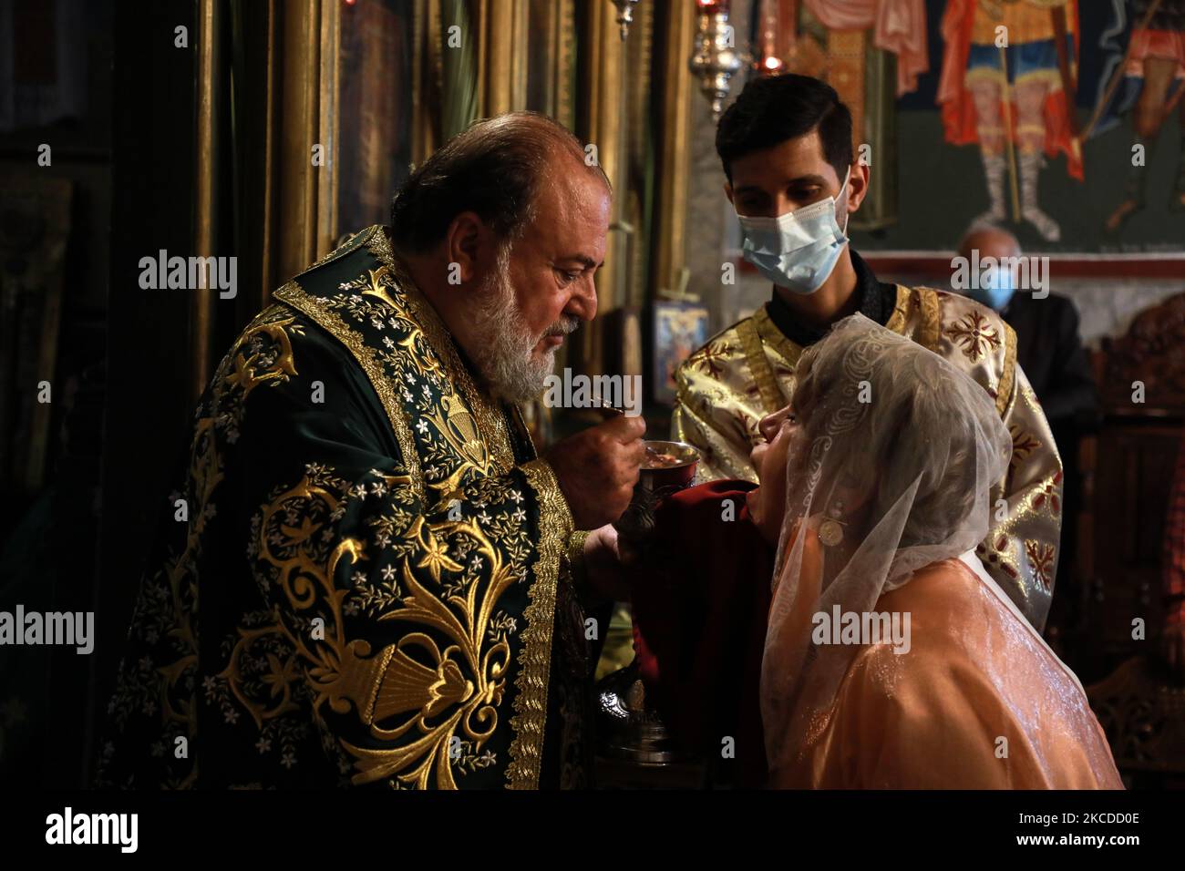 Christians take part in Palm Sunday Mass in the Church of Saint ...