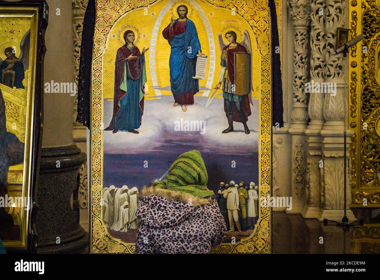 A child kisses a religious painting with motives of Chernobyl workers ...