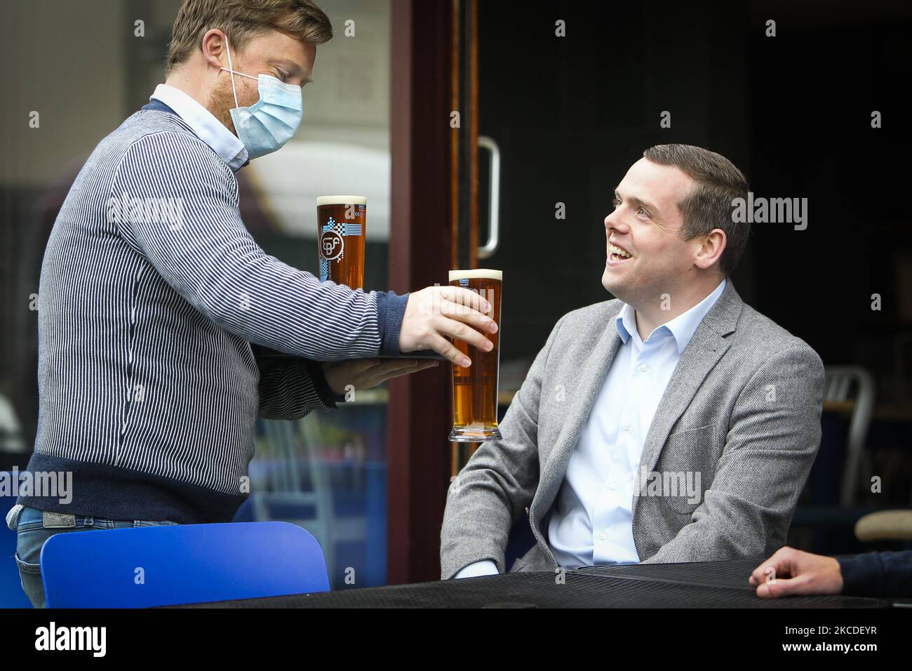 Staff member james sutherland hands scottish conservative leader ...