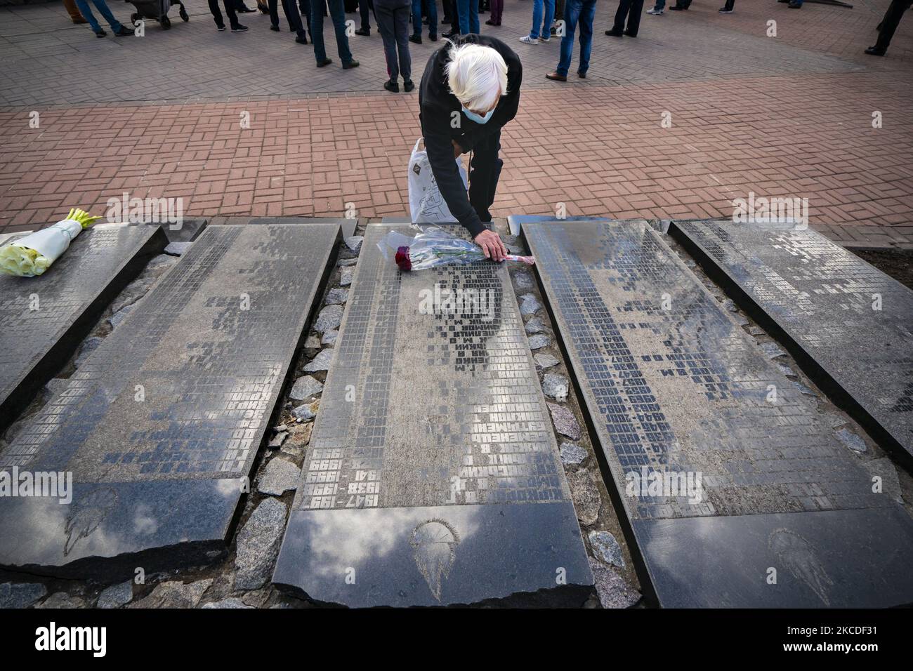 A man lays flowers in the memorial of the dead Chernobyl workers during ...