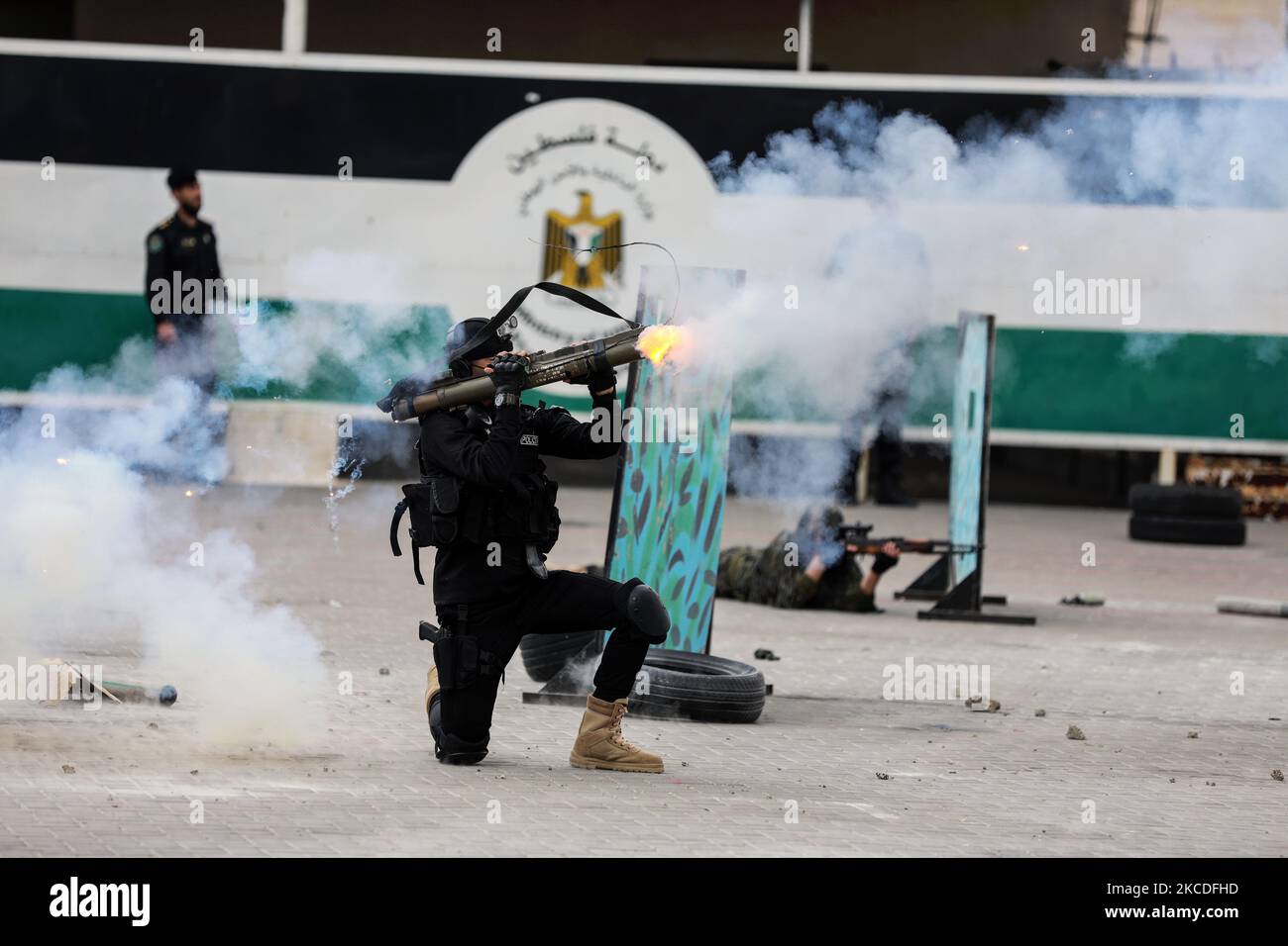 A Palestinian member of Hamas' security forces fires a rocket-propelled ...