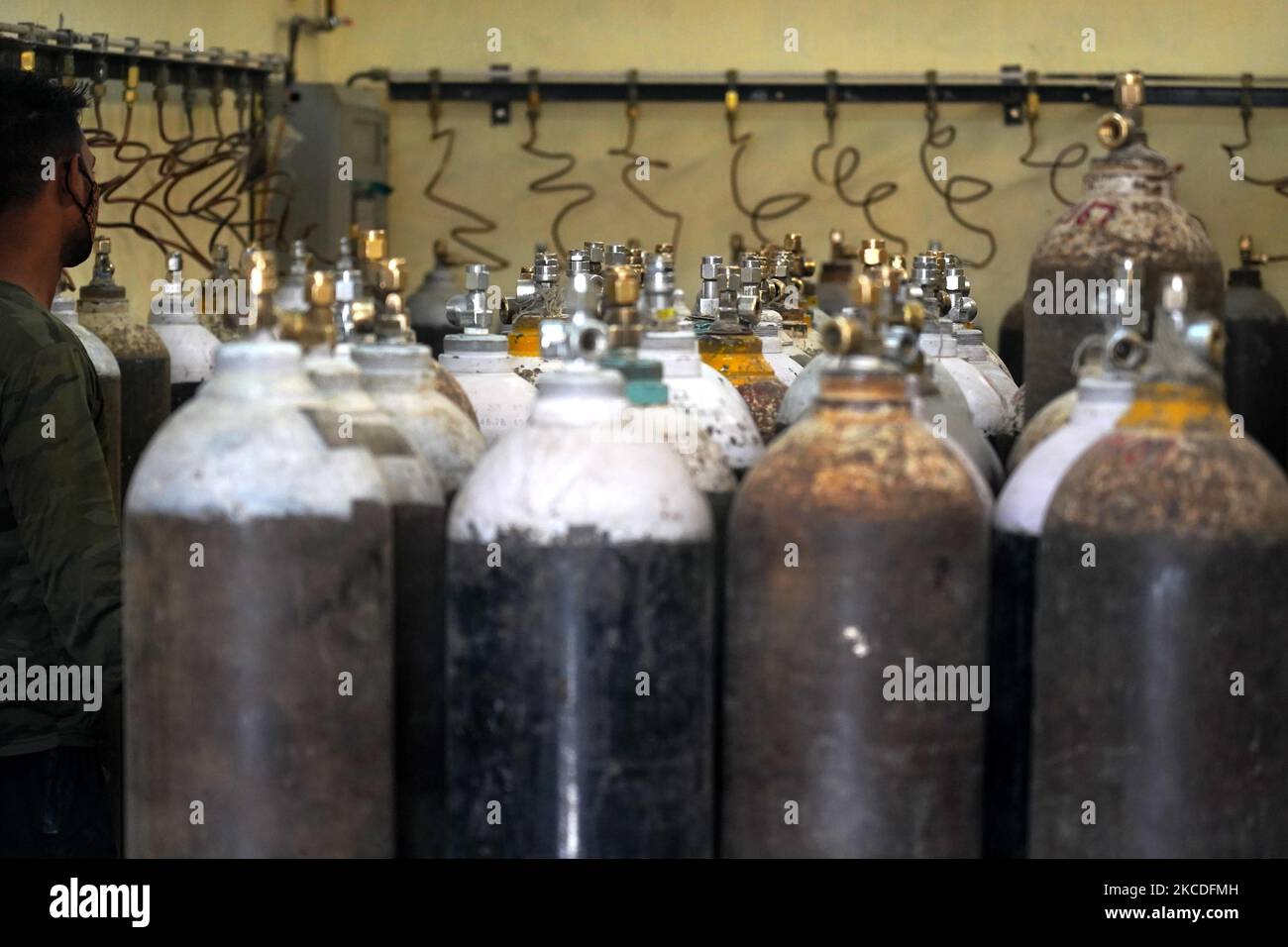 Workers Sort Oxygen Cylinders Used For Covid-19 Coronavirus Patients At ...