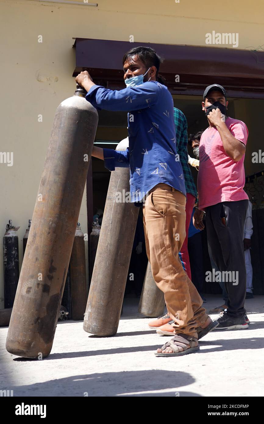 Workers Sort Oxygen Cylinders Used For Covid-19 Coronavirus Patients At ...