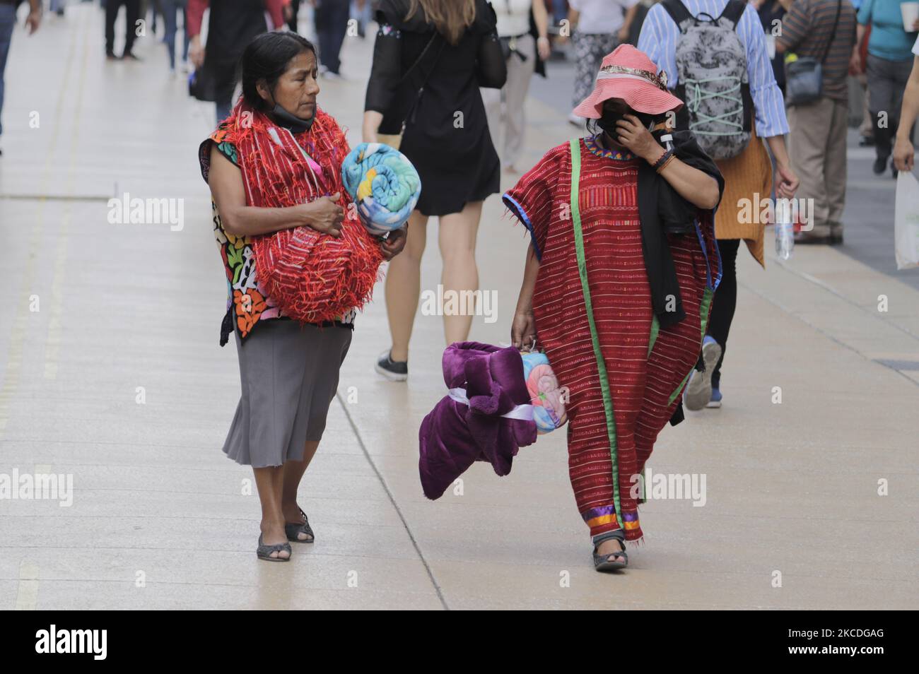 Two women from the Triqui community walk in the streets of Mexico City ...