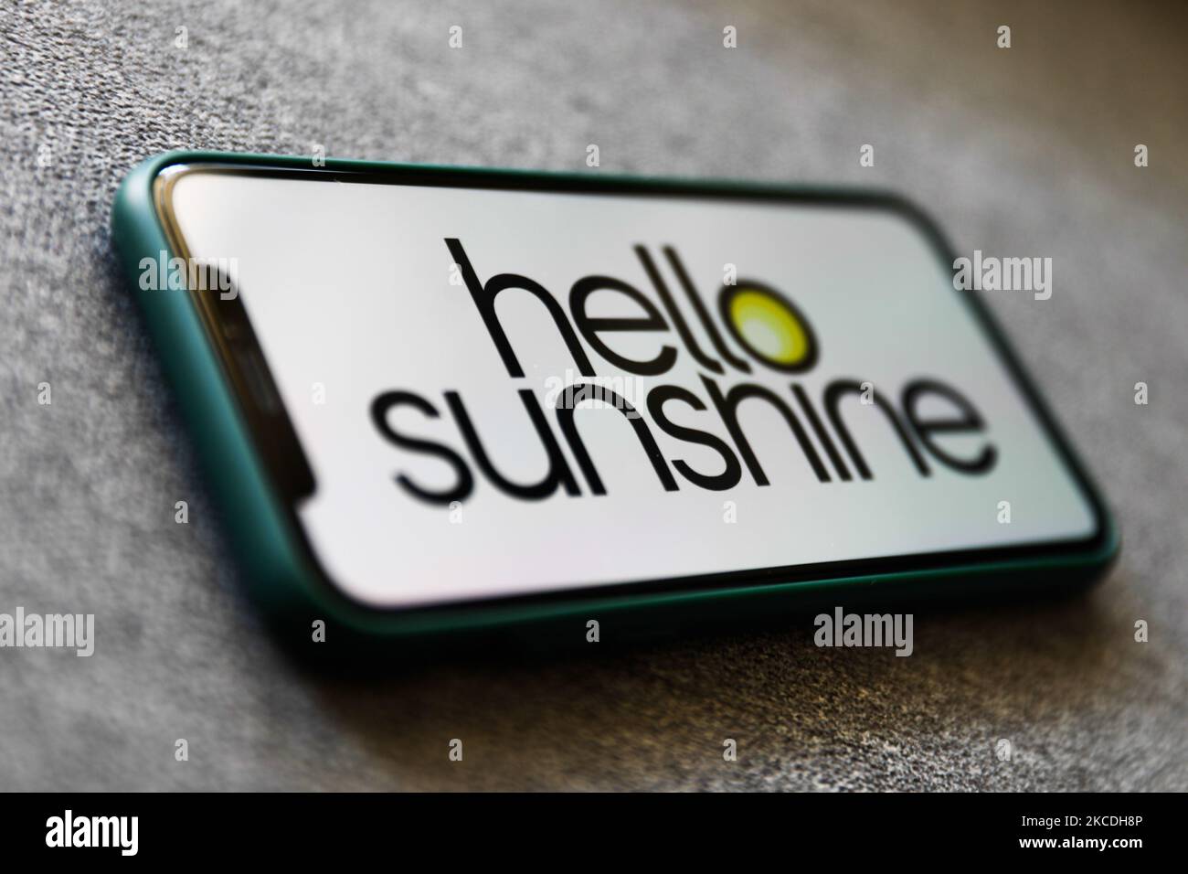 Hello Sunshine logo is seen displayed on a phone screen in this ...