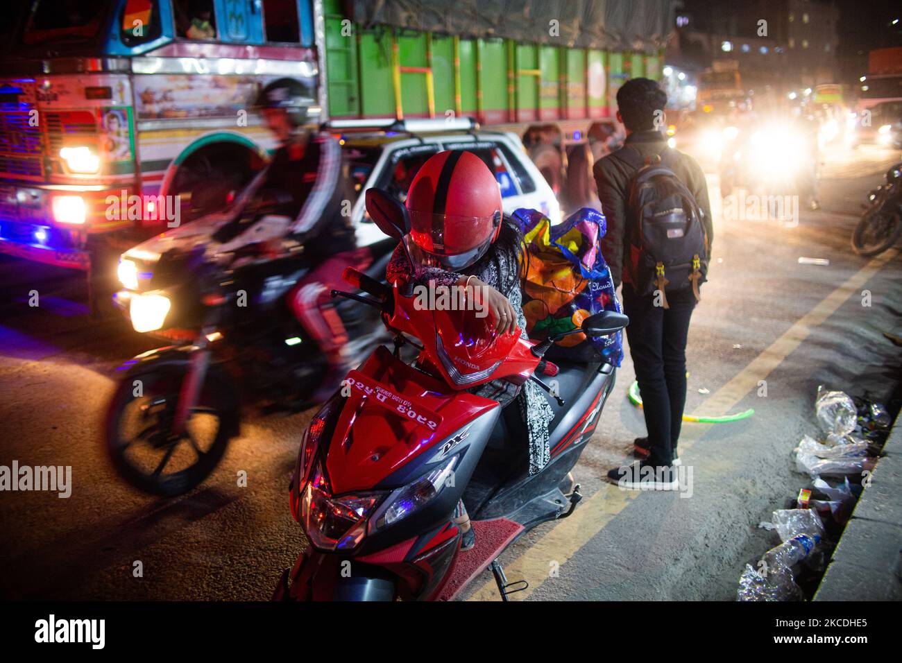 A woman waits to head towards her villages after the government re ...