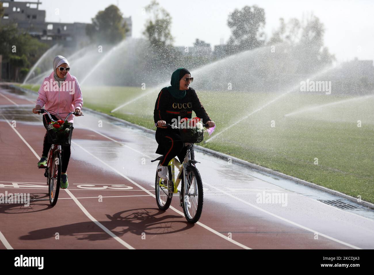 Palestinian women ride bicycles at the Yarmouk Stadium in Gaza city on ...