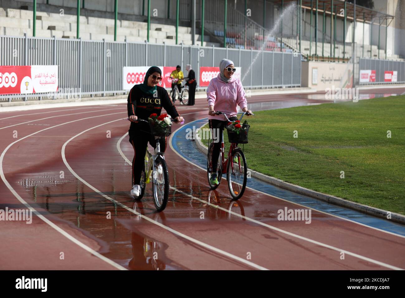 Palestinian women ride bicycles at the Yarmouk Stadium in Gaza city on ...