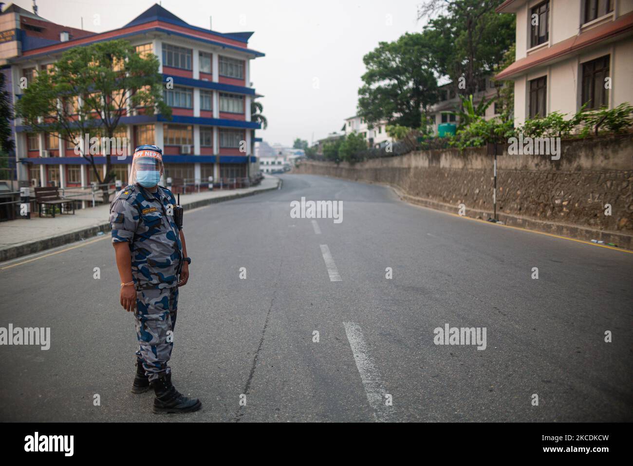 Nepalese police stand guard during the first day of a two-week lockdown ...