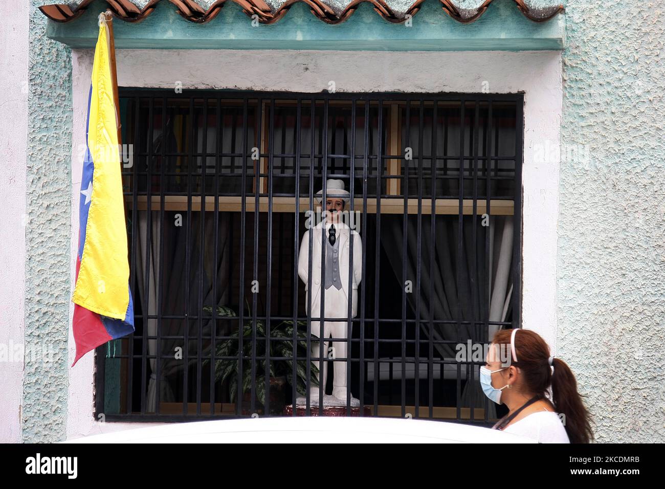A woman walks near an altar of the Venezuelan saint José Gregorio ...