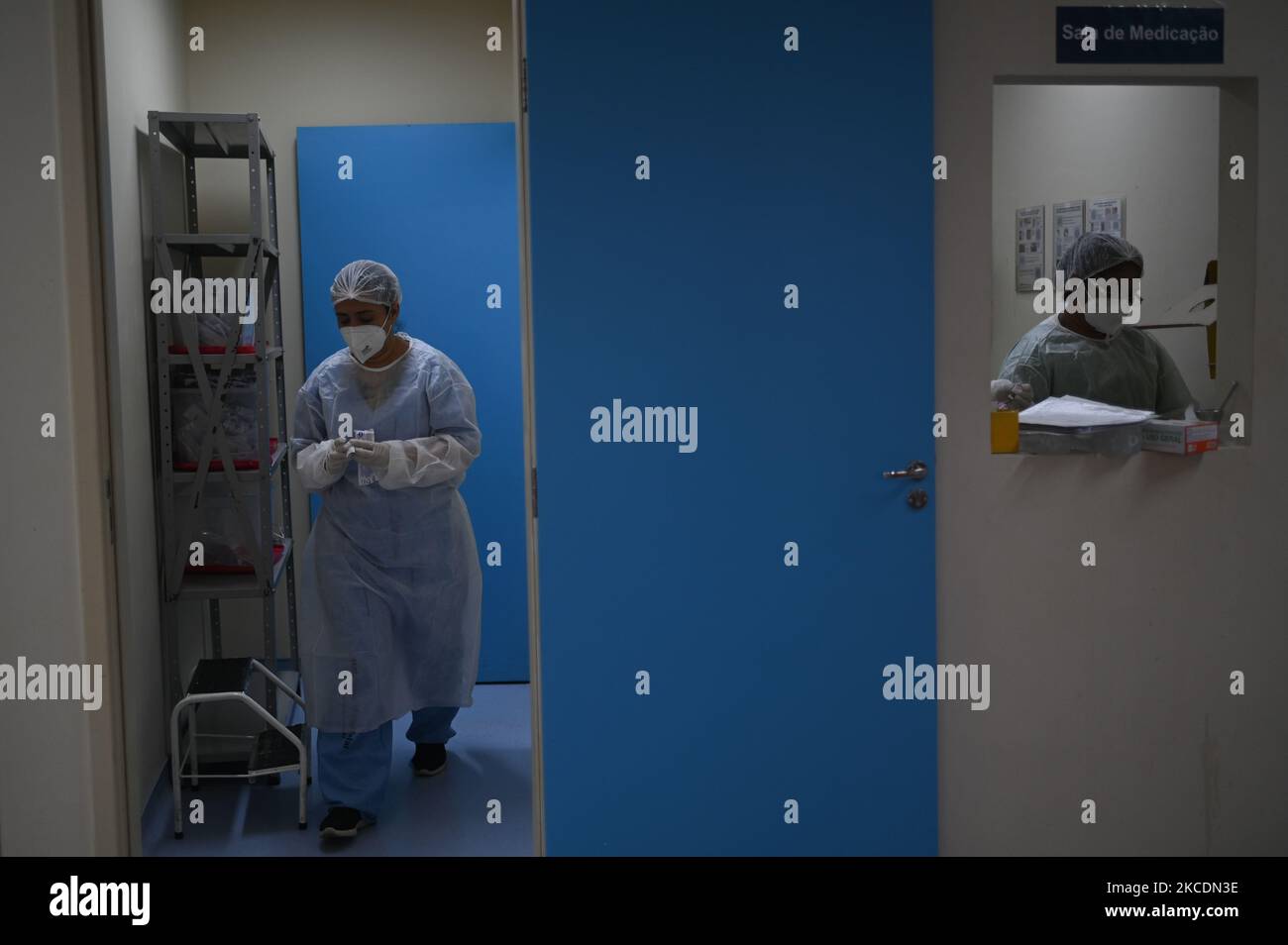 Medical workers are seen in a medication room for coronavirus disease ...