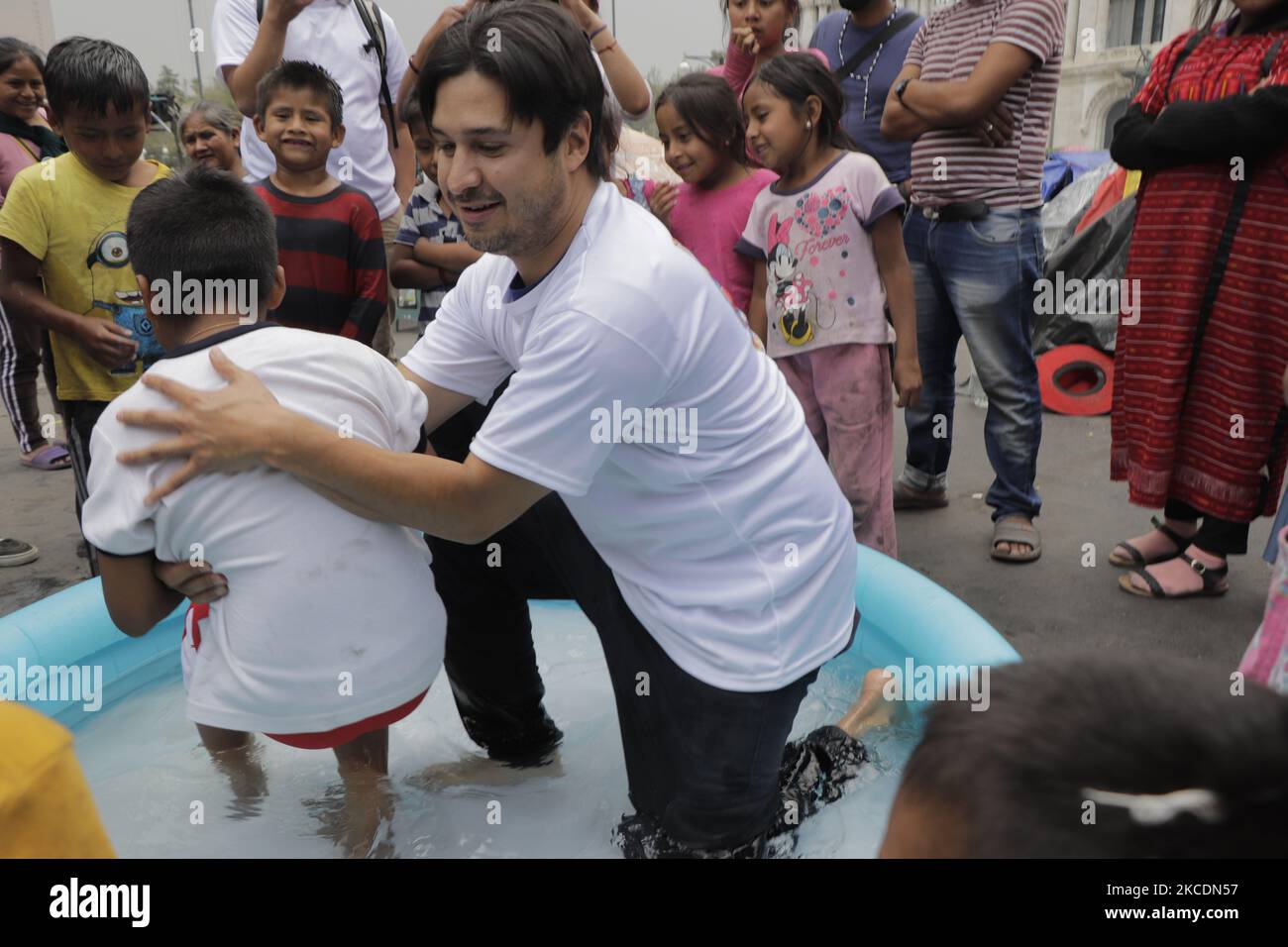 Members of House of Hope, perform a symbolic collective baptism in an ...