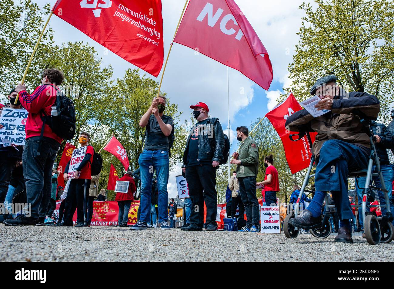 An old man is reading a flyer from a syndicate, while others are ...
