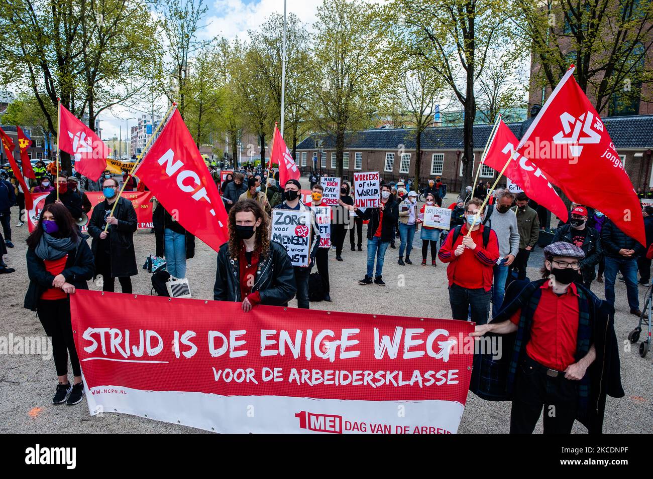 Groups of people are holding flags from several worker unions, during ...