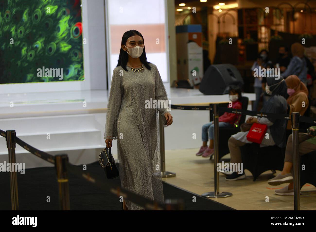 A model presents on the catwalk a creation of Indonesian fashion outfit ...