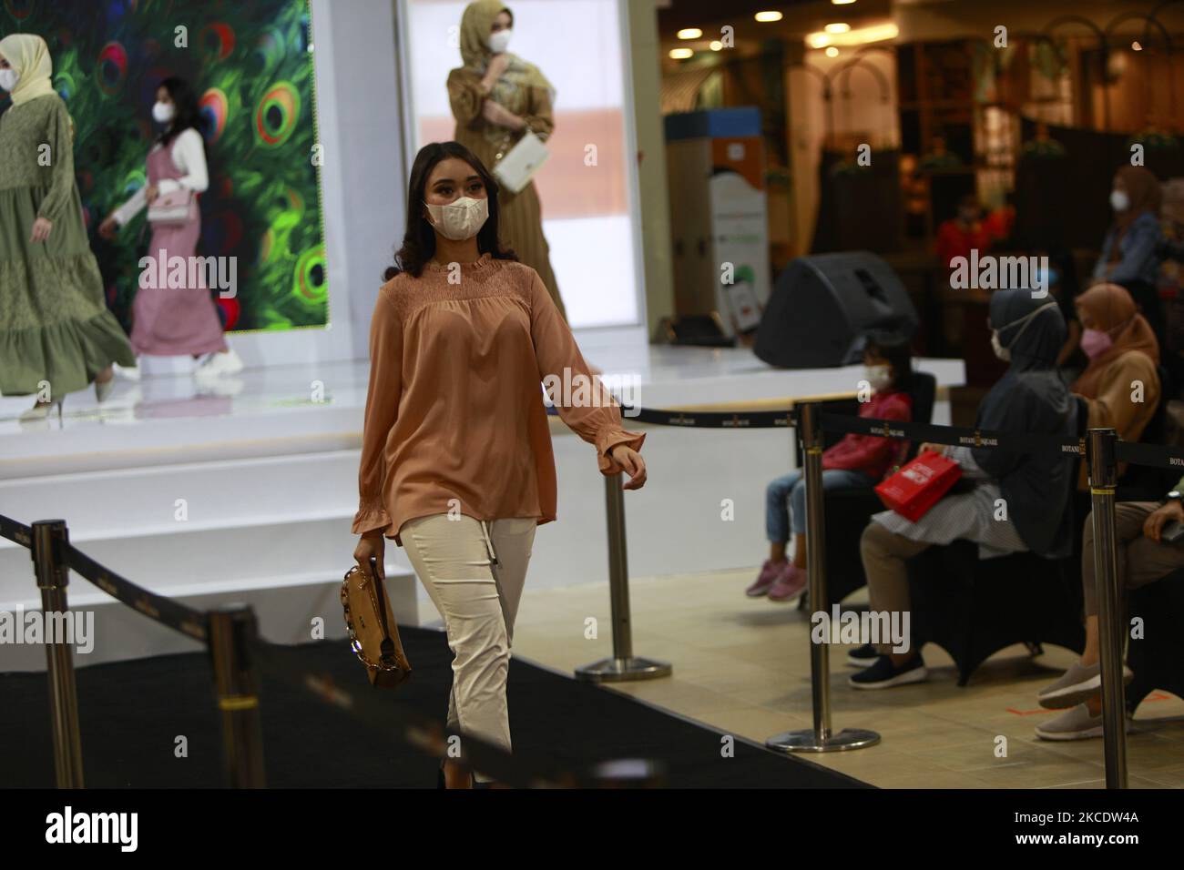 A model presents on the catwalk a creation of Indonesian fashion outfit ...