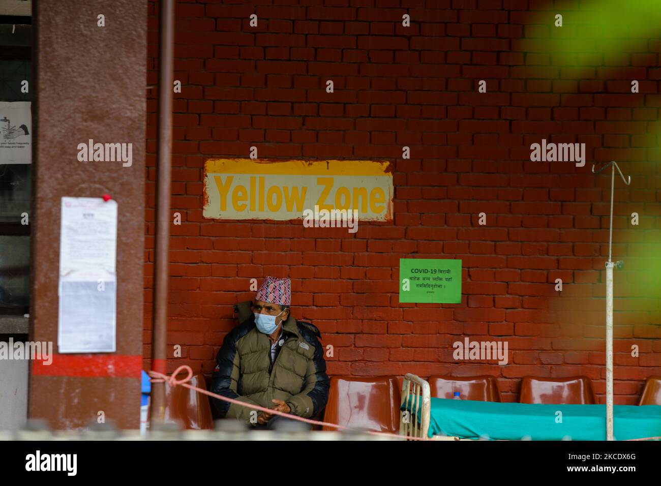 A man infected with Covid-19 waits at the yellow zone before being ...