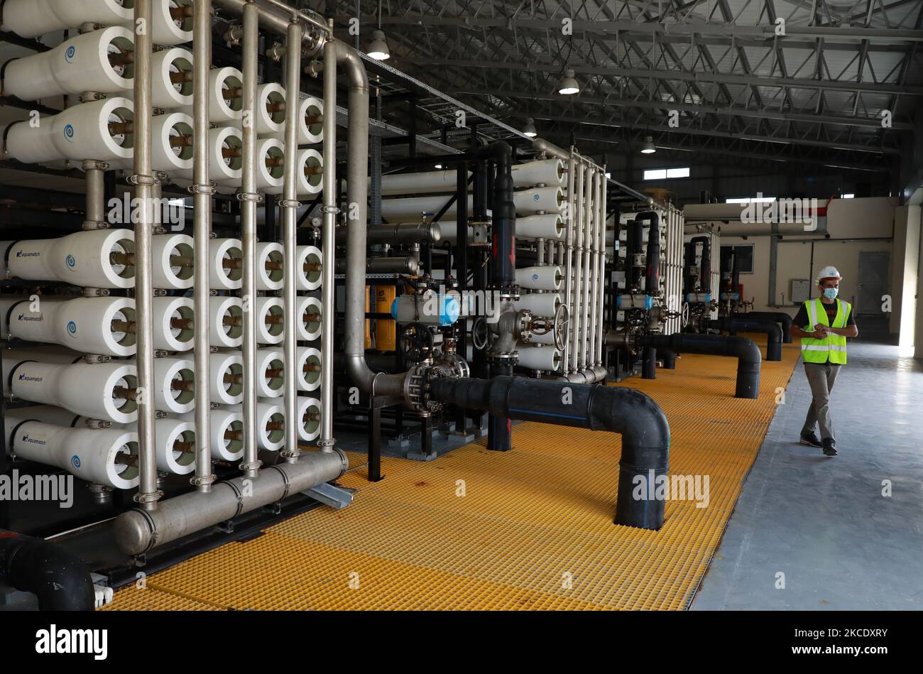 A Palestinian engineer works at a plant to convert seawater into fresh ...