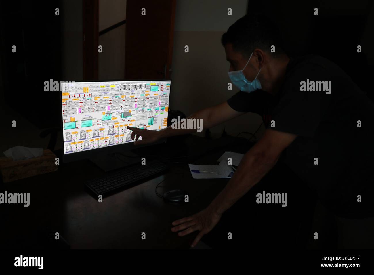 A Palestinian engineer works at a plant to convert seawater into fresh ...