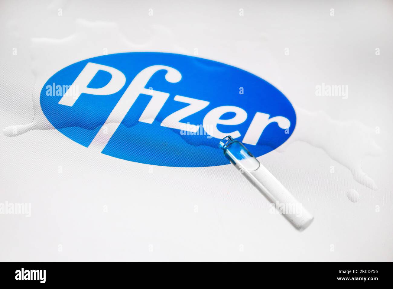 Pfizer vaccine manufacturer logo is photographed with a vial and ...