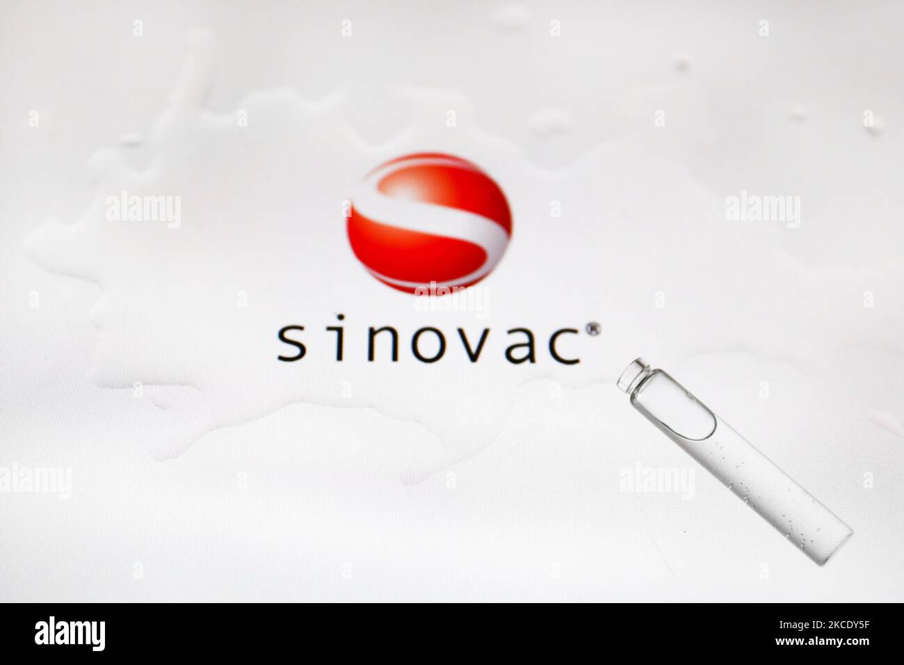 Sinovac vaccine manufacturer logo is photographed with a vial and ...