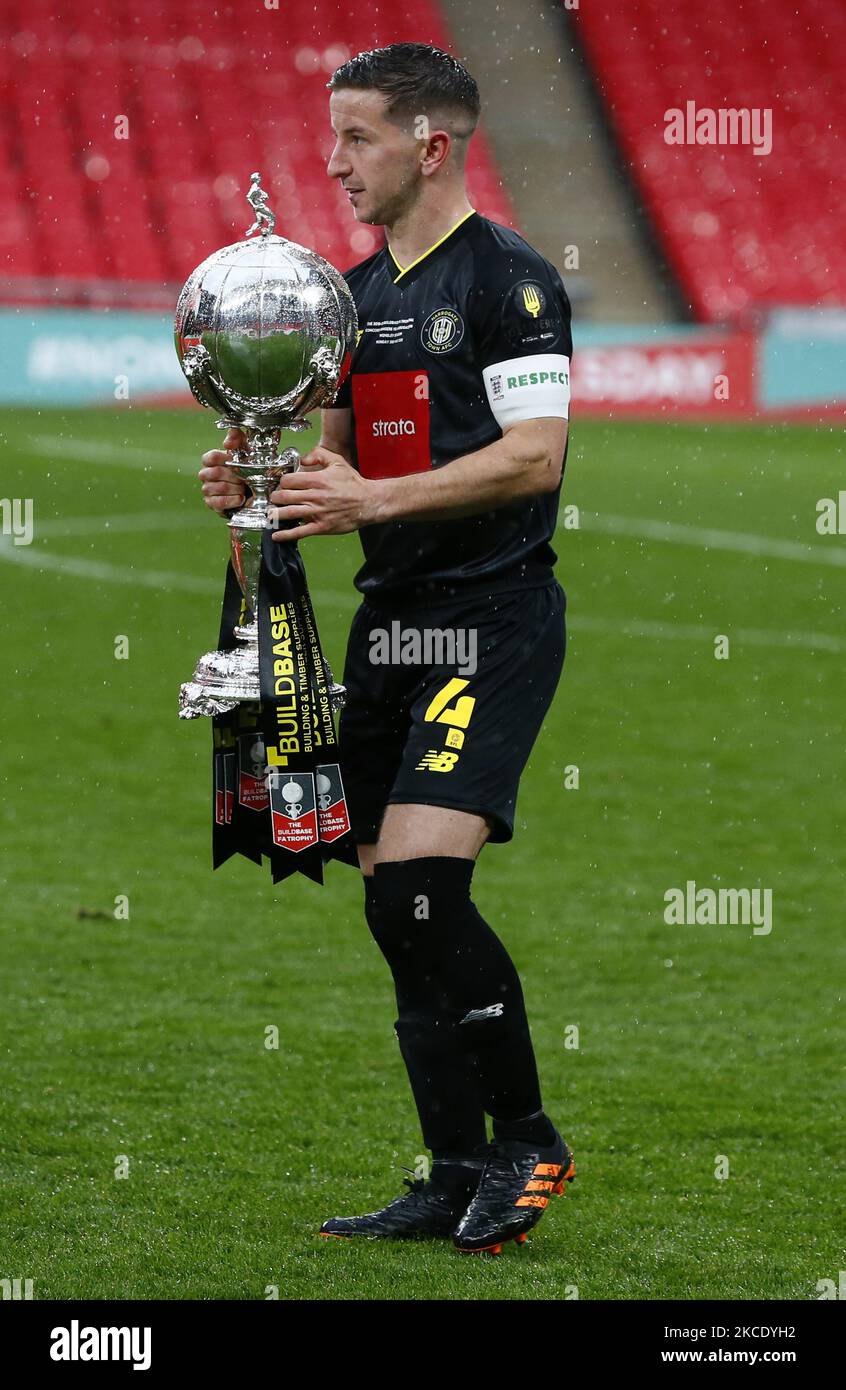 Josh Falkingham of Harrogate Town holds The Buildbase FA Trophy during ...