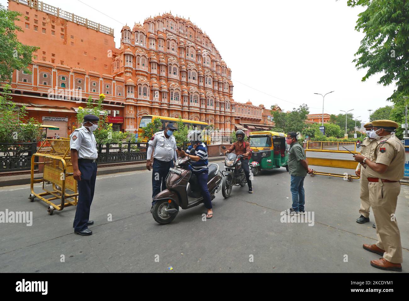 Security personnel check commuters during COVID-induced lockdown at ...