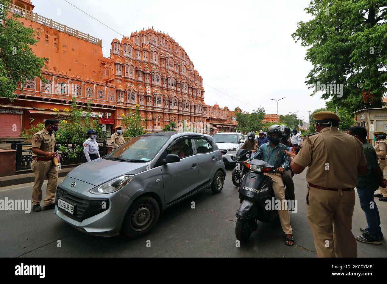 Security personnel check commuters during COVID-induced lockdown at ...