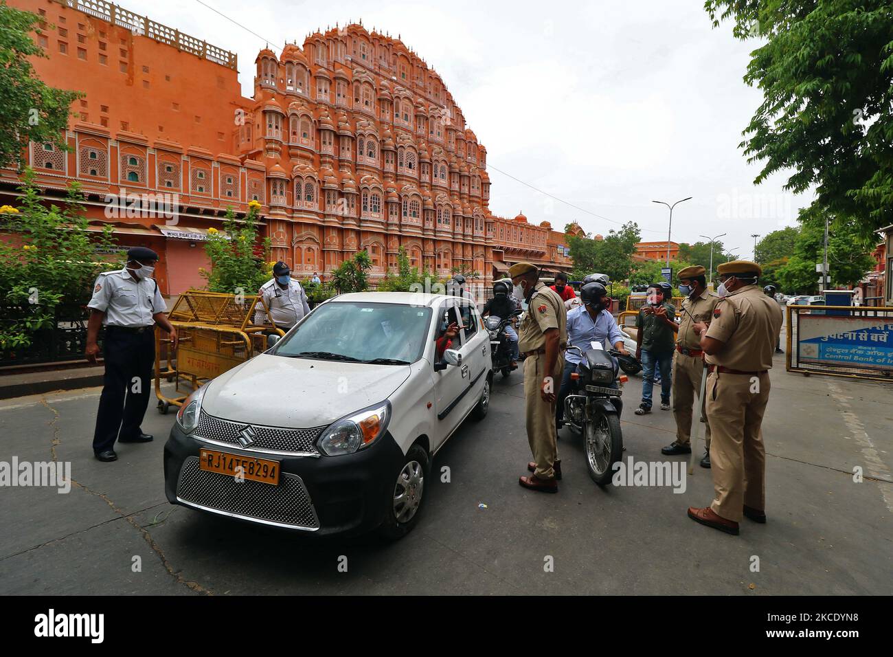 Security personnel check commuters during COVID-induced lockdown at ...