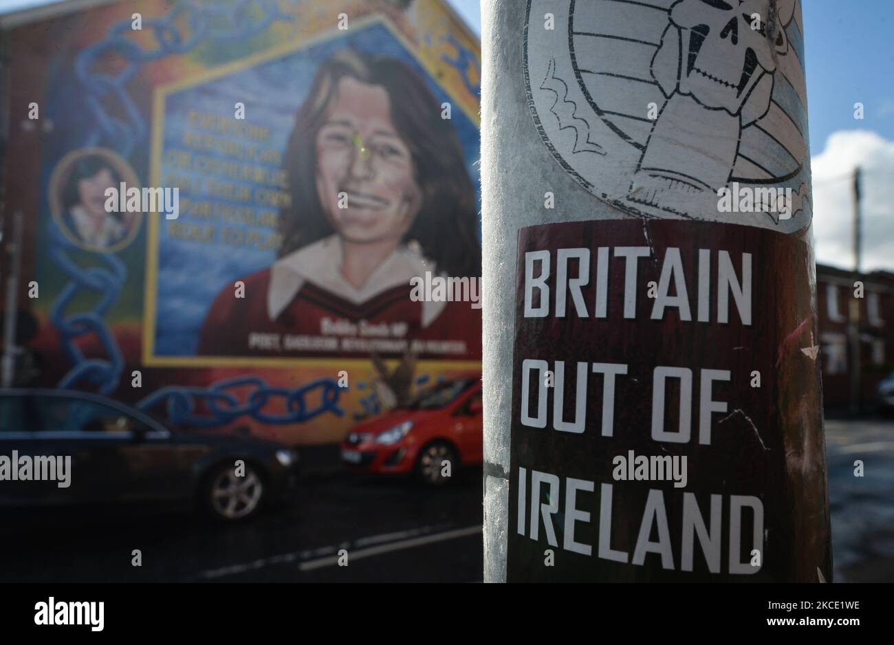 A sticker 'Britain Out Of Ireland' in front of the memorial mural to ...