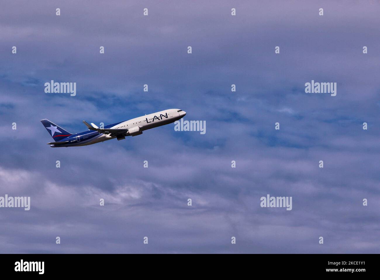 LAN Airlines airplane seen flying above the small town of Hanga Roa in ...
