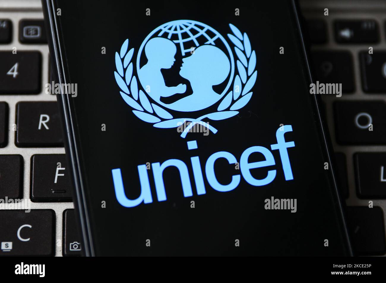 UNICEF logo is displayed on a mobile phone screen photographed for ...