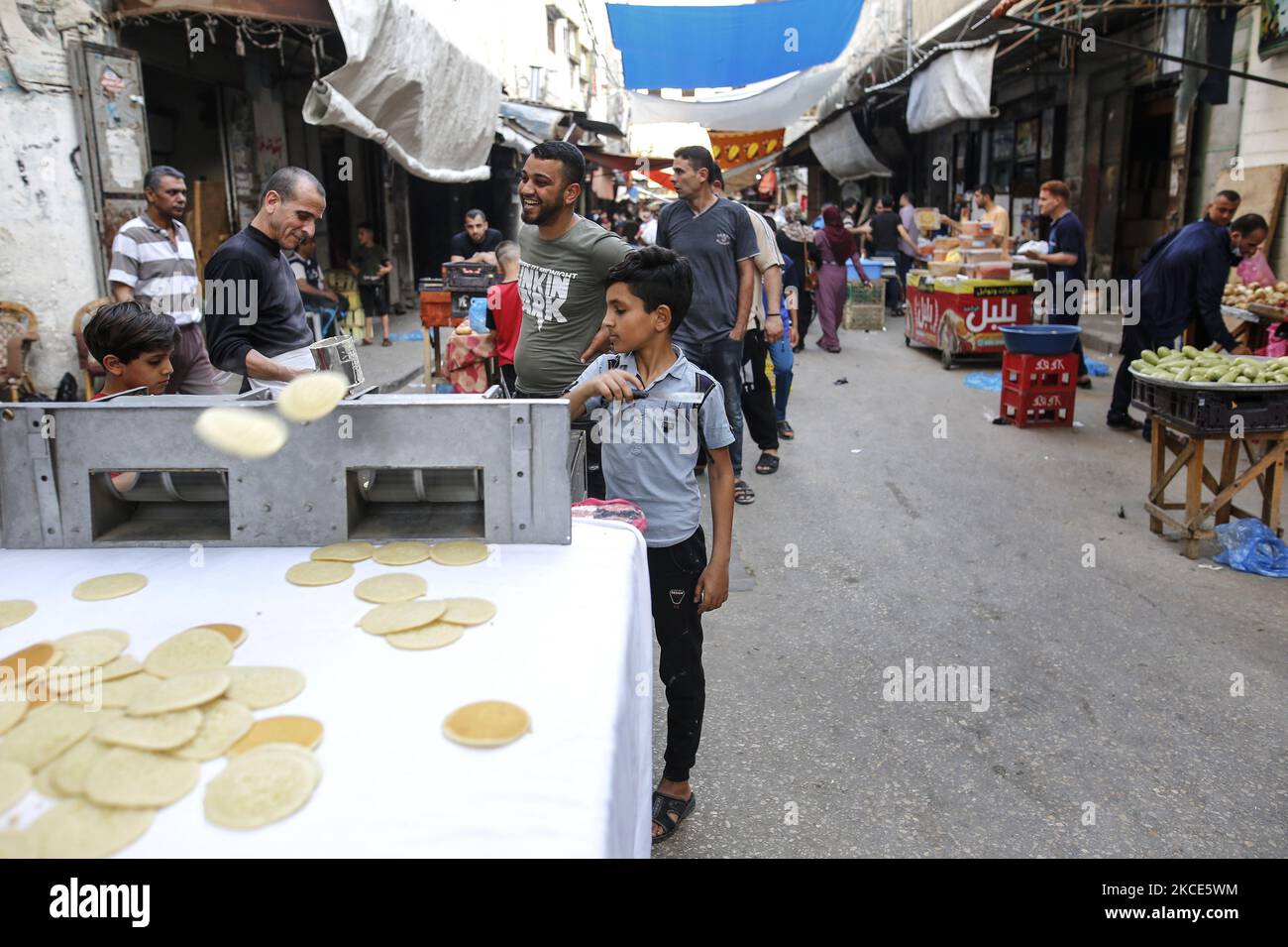 A Palestinian makes traditional sweets known as ,Qatayef, a dessert ...