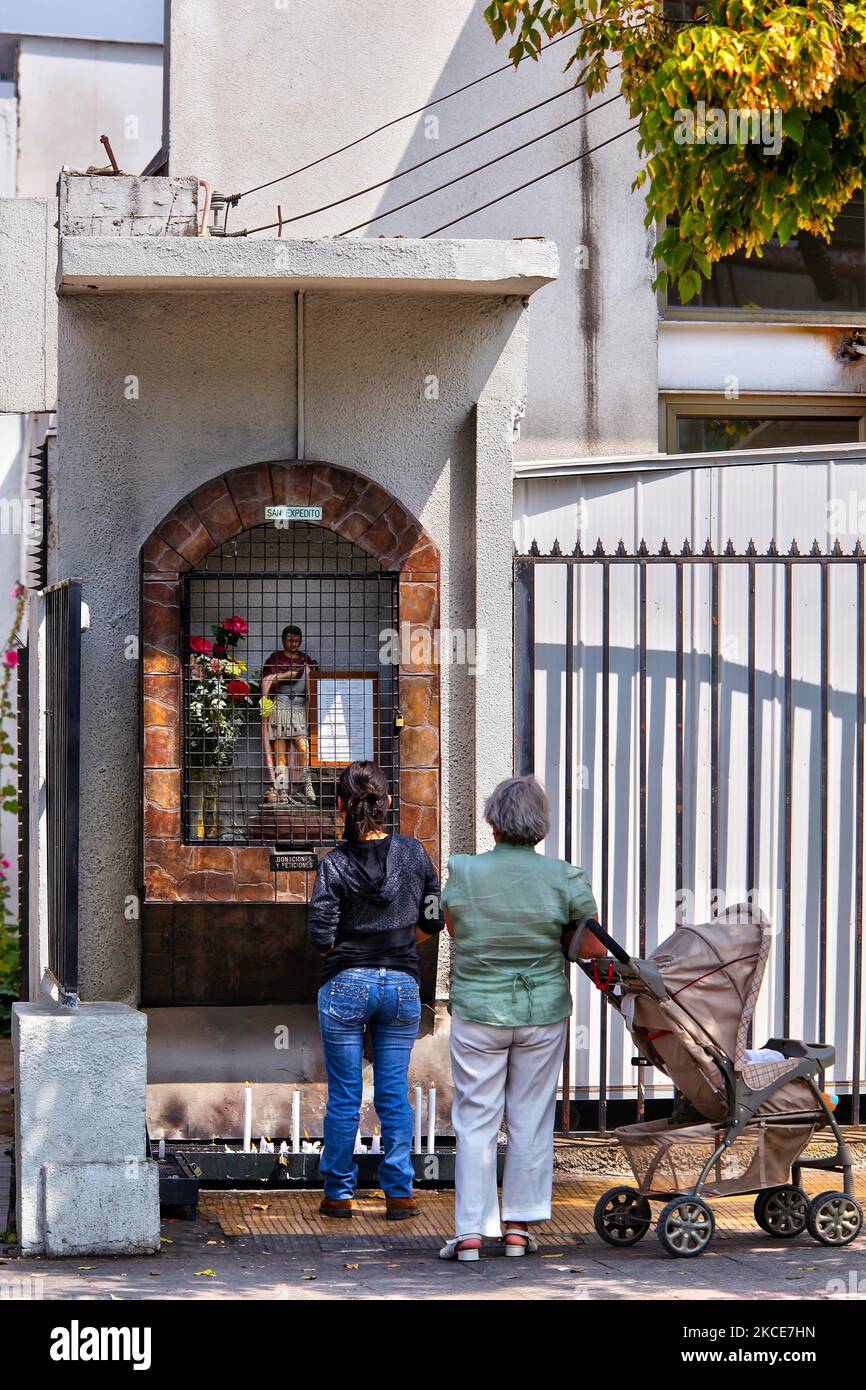 People offer prayers at a small shrine to Saint Expeditus outside a ...