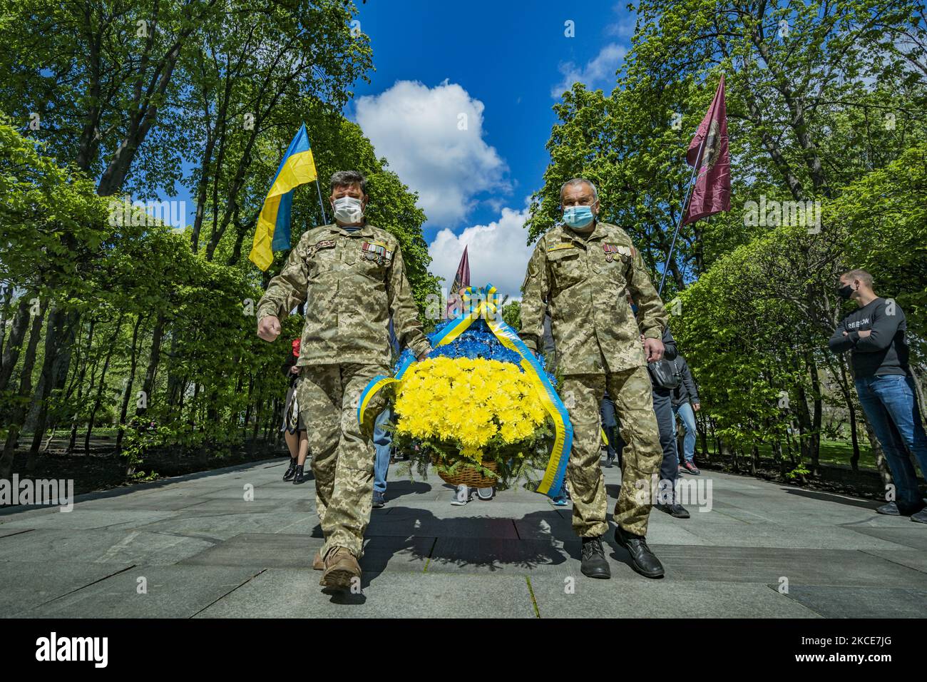 Ukrainian soldiers attend with flowers the celebrations in remembrance ...