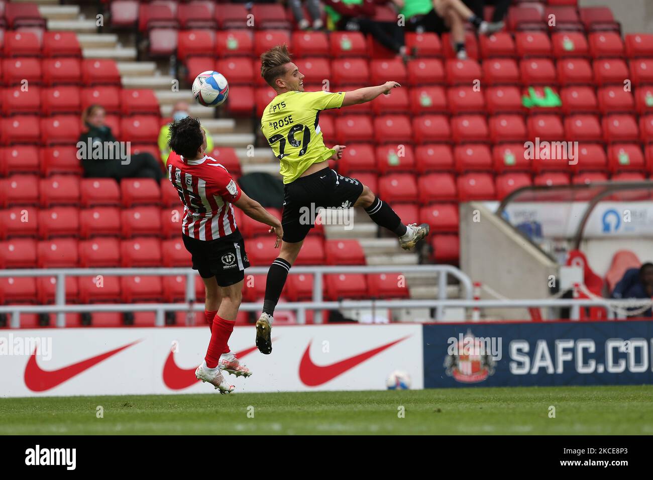 Danny Rose of Northampton Town contests a header with Sunderland's Luke ...