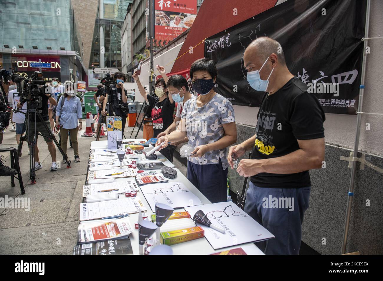 Workers standing at a booth for the June 4 Vigil in Hong Kong, Sunday ...