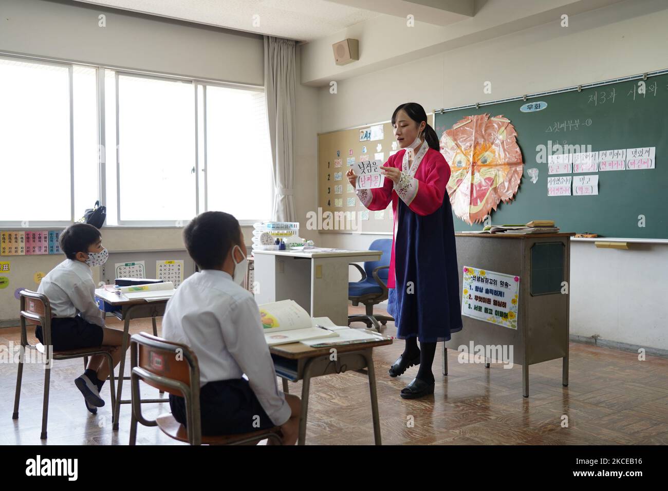 A teacher wearing a Korean traditional dress conducts a Korean lecture at Hiroshima Korean ...