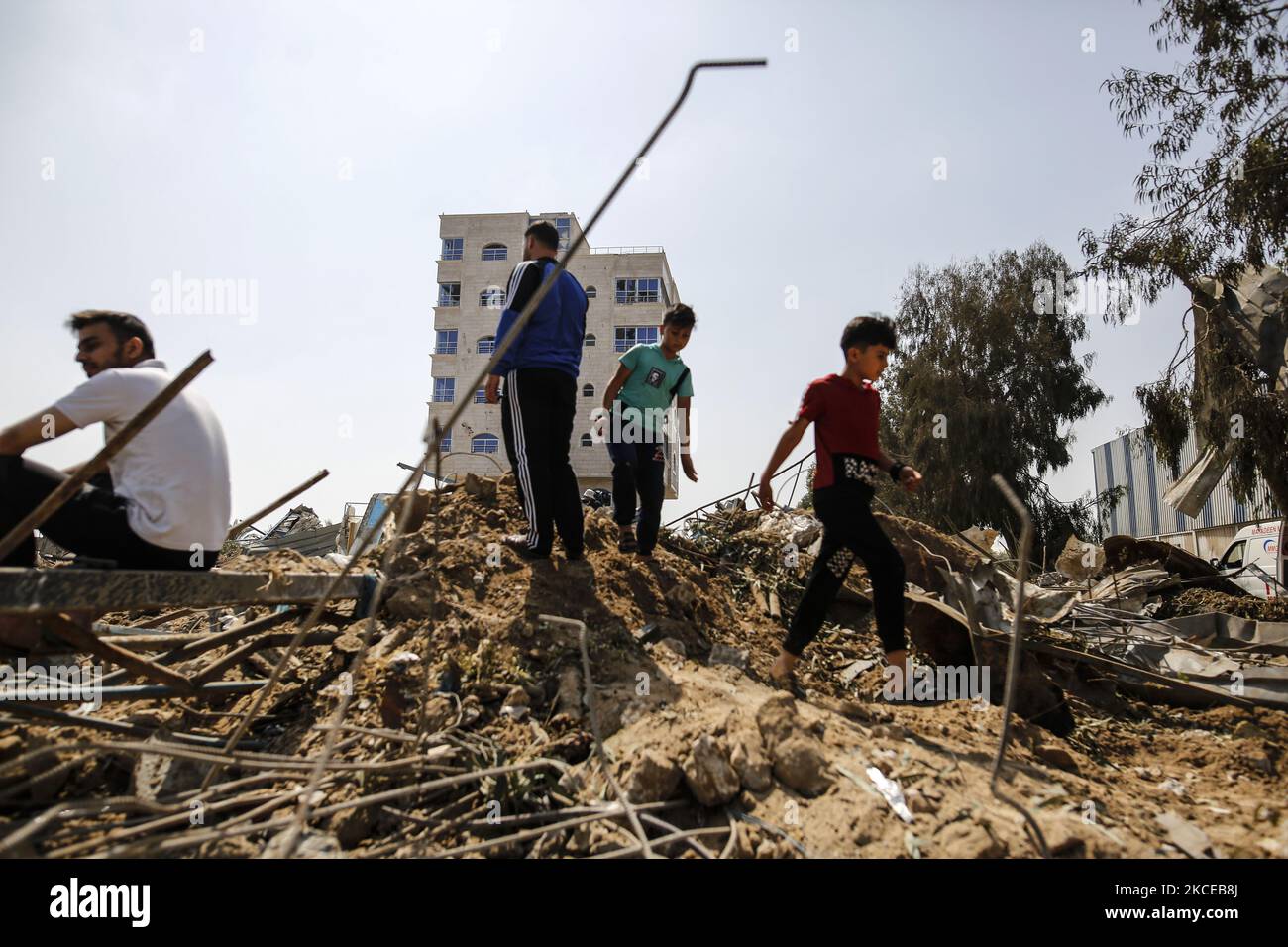 Palestinian gather near the rubble of an ice factory and mechanic ...