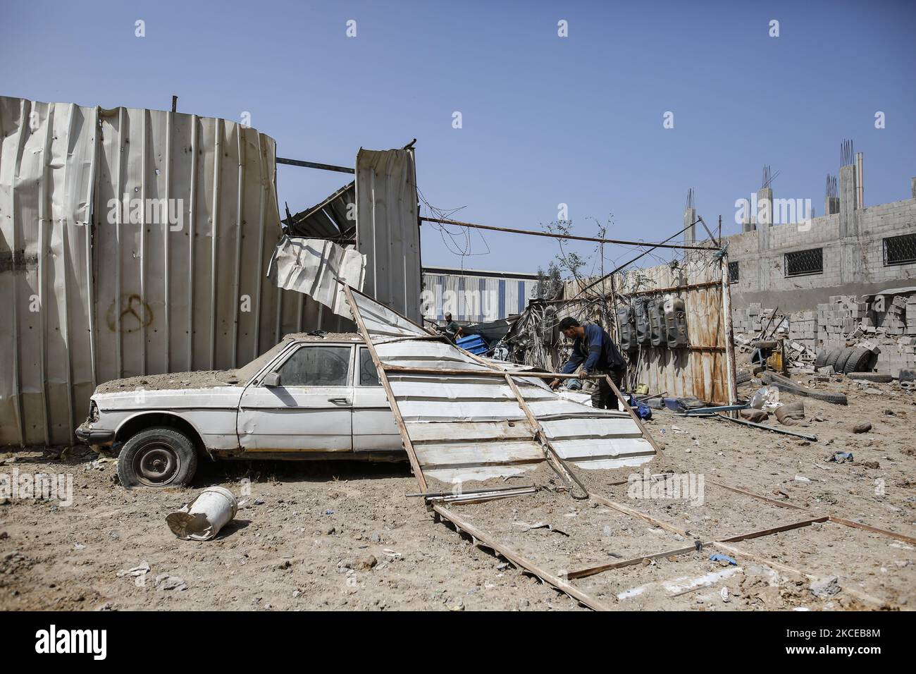 A palestinian man near the rubble of his mechanic garages that were ...
