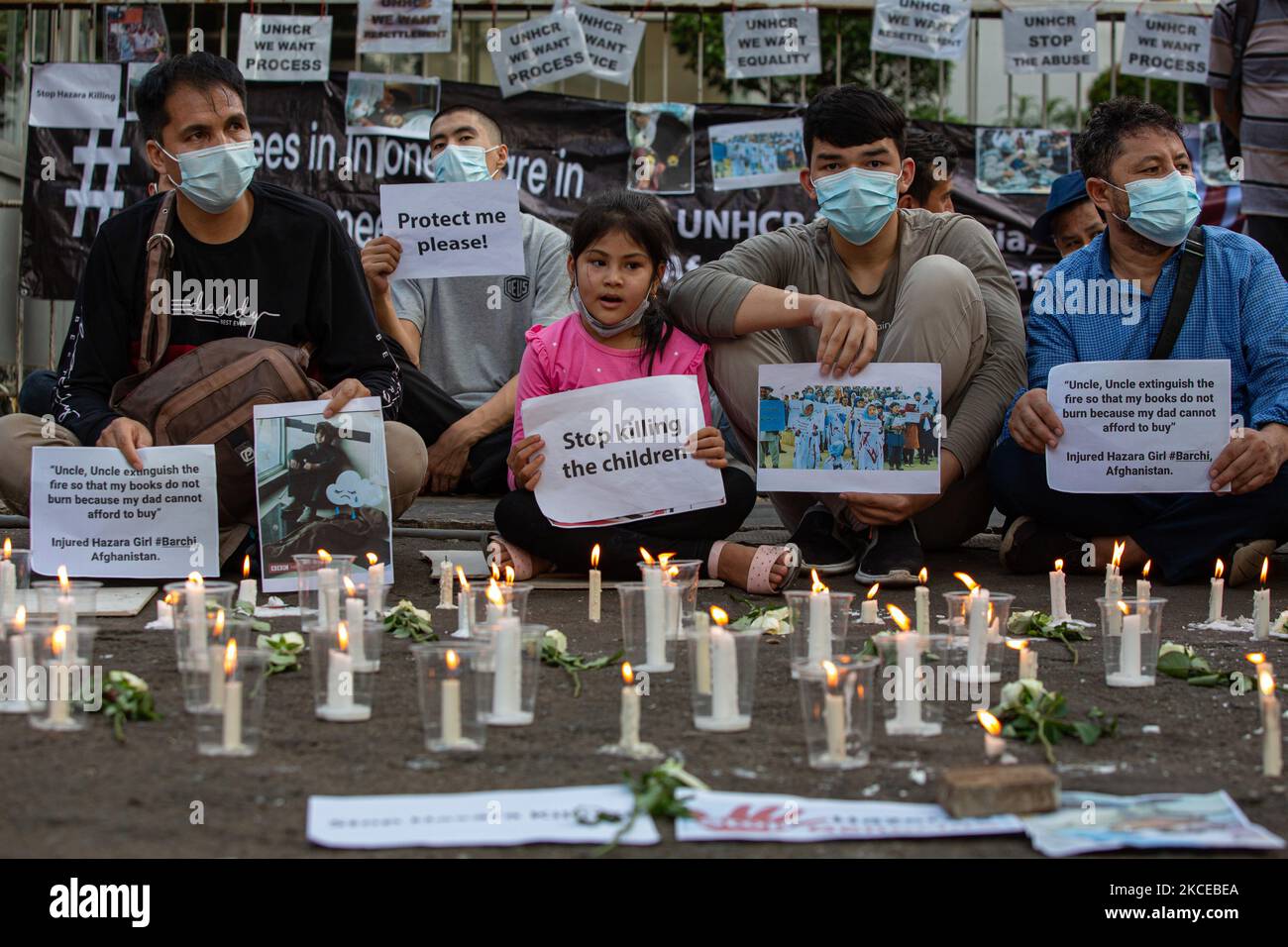 Refugees members of the Shiite Hazara community carries a placards to ...