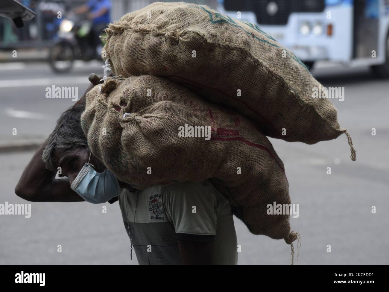 A man carrying heavy lorded onions near Colombo, Sri Lanka May 12, 2021 ...